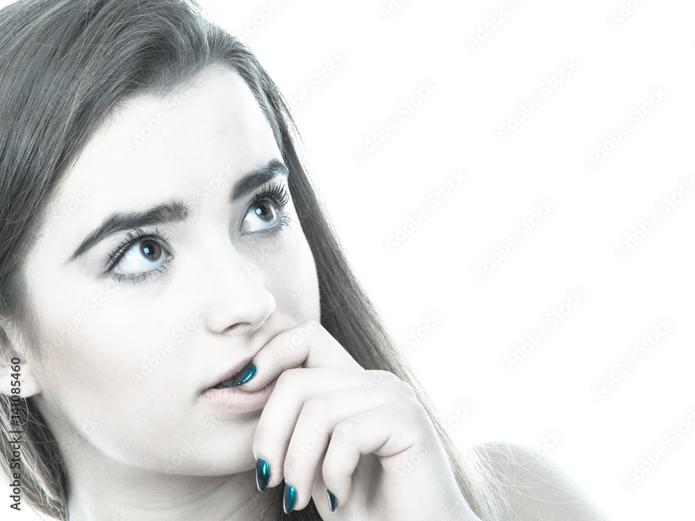 Foto stock di Teenage woman looking worried, thinking about something ...