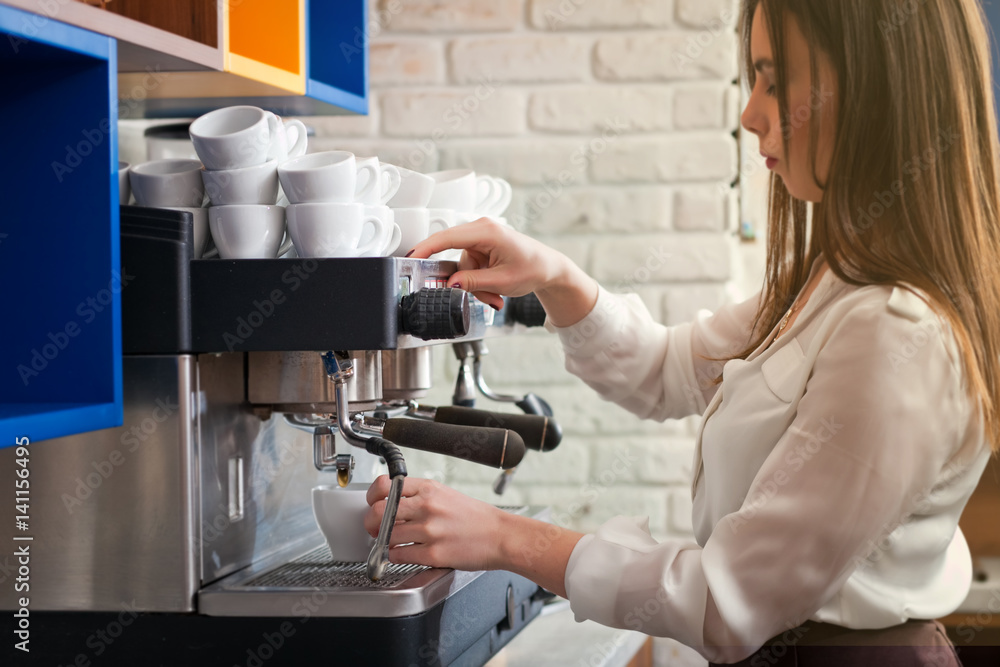 young girl preparing coffee in a cafe barista Stock Photo | Adobe Stock