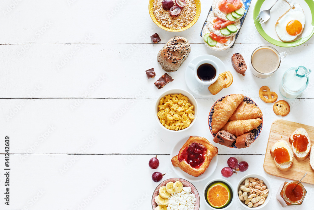 Breakfast menu food frame with a copy space. Eggs, croissants, oatmeal ...