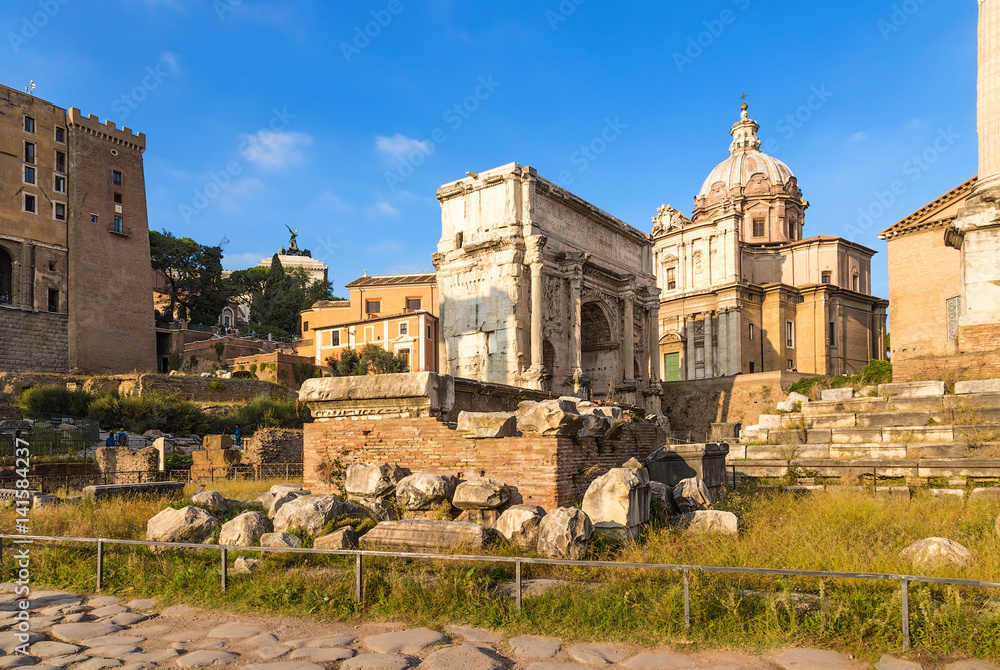 Rome, Italy. Ruins of Rostra and the triumphal arch of Septimius ...