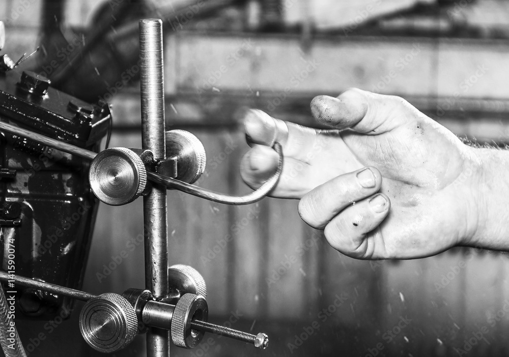 Professional mechanics testing diesel injector in his workshop, repair ...