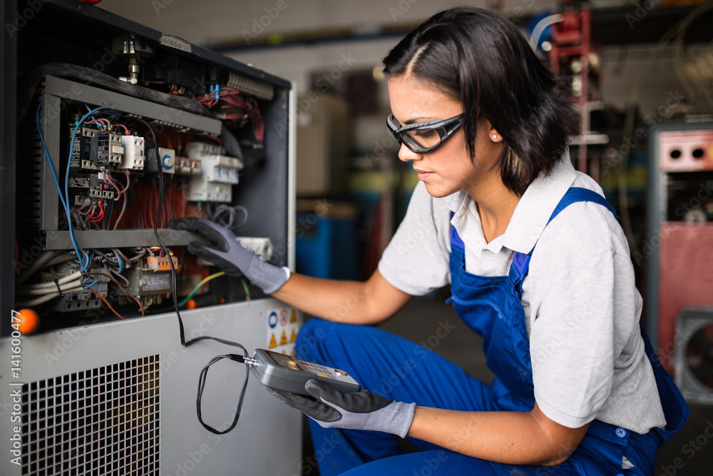 Female mechanic fixing a compressor engine Stock Photo | Adobe Stock