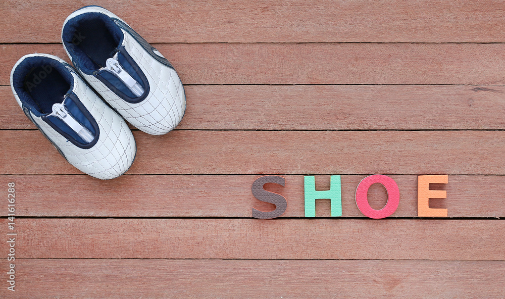 Cute baby shoes on wood plank with text "SHOE", Little shoe on wood ...