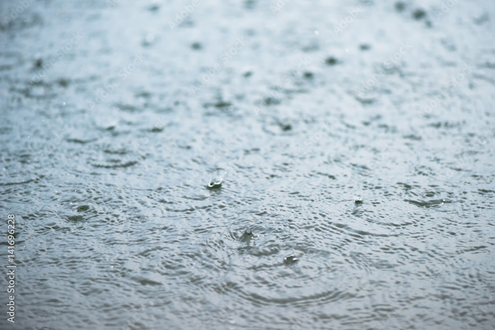 Raindrop on rippling water surface Stock Photo | Adobe Stock