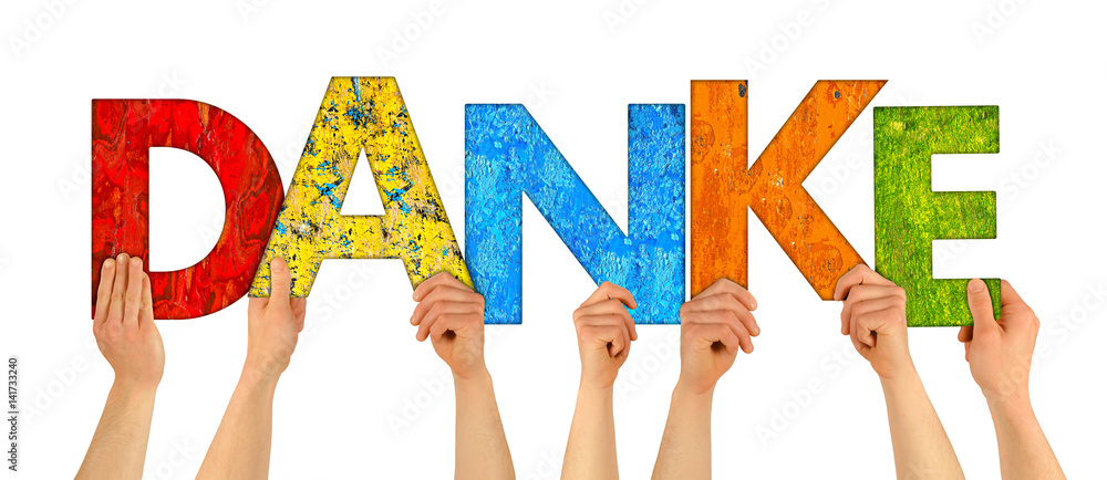 hands holding up colorful letters shaping the german word thank you ...