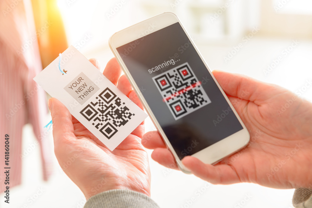 Woman scanning QR code Stock Photo | Adobe Stock