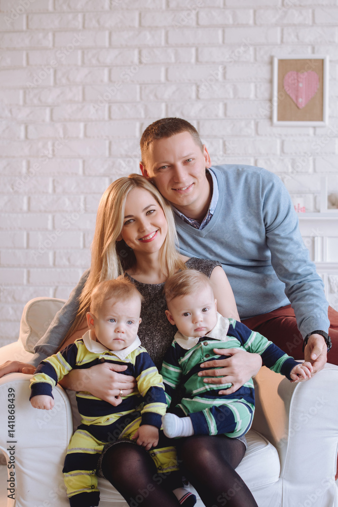 Happy family portrair. Parents with baby two boys twins.Portrait of ...