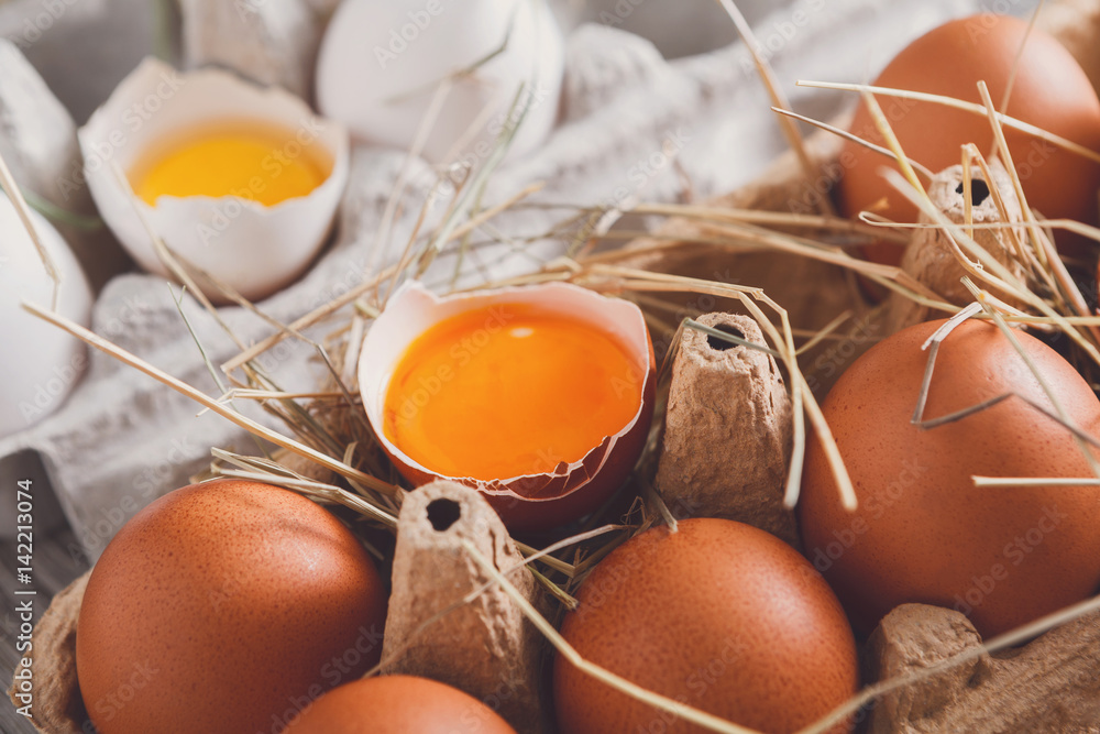 Eggs carton. Healthy food background. Yellow yolk Stock Photo | Adobe Stock