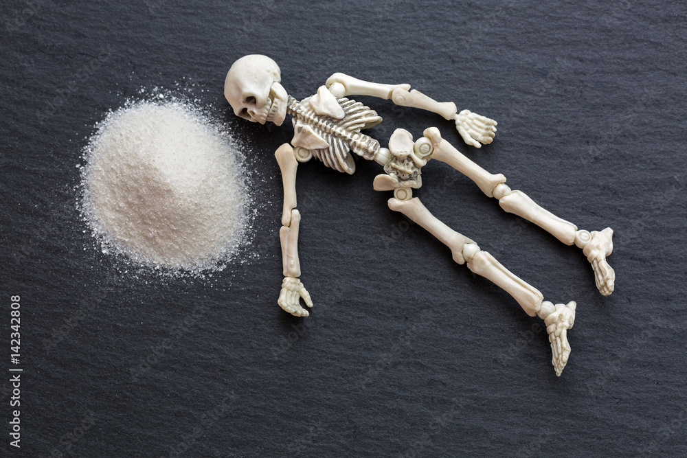 White skeleton dead body bones resting next to dangerous white fine ...