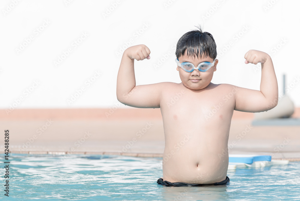 obese fat boy show muscle in swimming pool Stock Photo | Adobe Stock