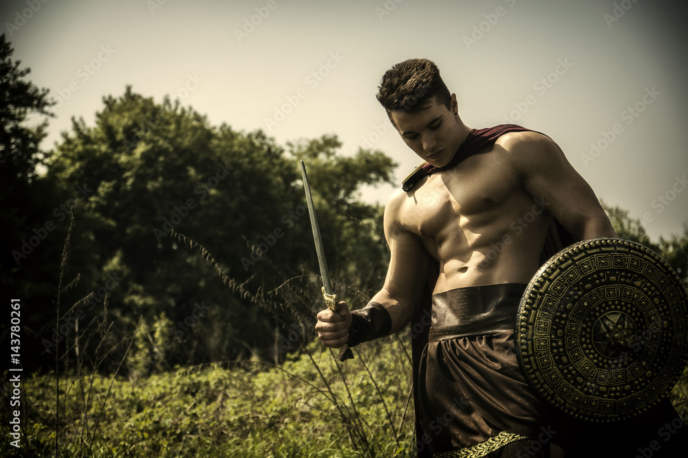 Young handsome muscular man posing in roman or spartan gladiator ...