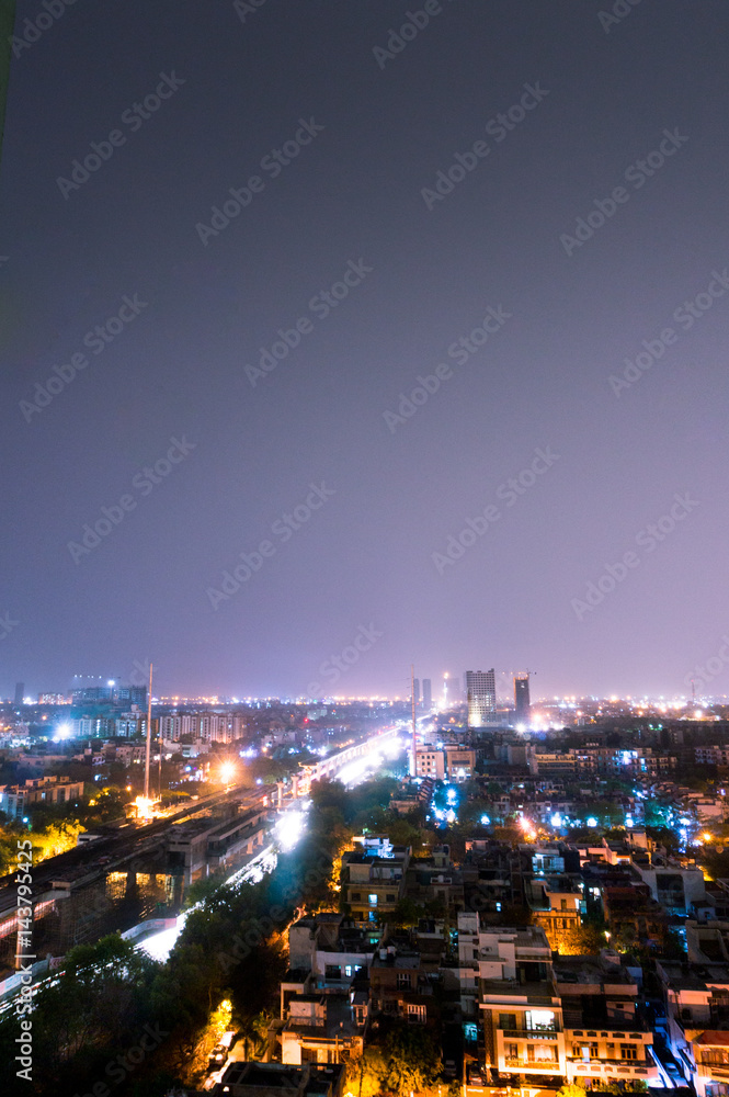 Noida cityscape at night with houses, office, skyscrapers, streets and ...