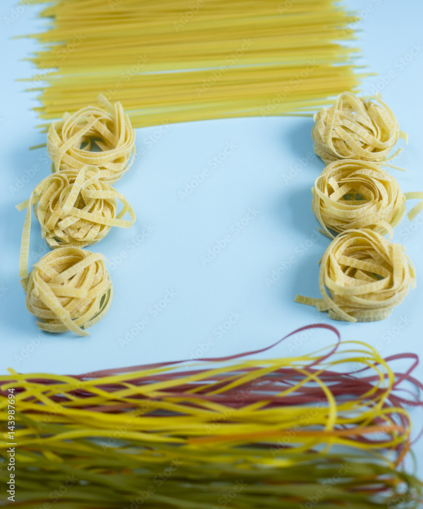 Different kinds of raw pasta. Macaroni of different shapes and colors ...