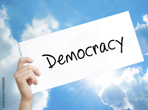 Democracy Sign on white paper. Man Hand Holding Paper with text ...