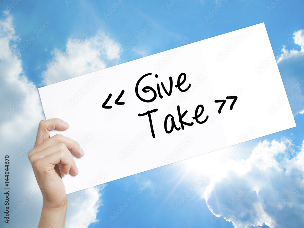 Give - Take Sign on white paper. Man Hand Holding Paper with text ...
