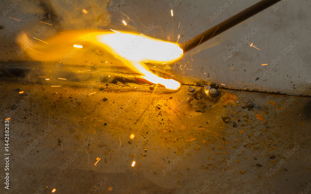 SMAW – Shielded matal arc welging and welding flame at spark point ...