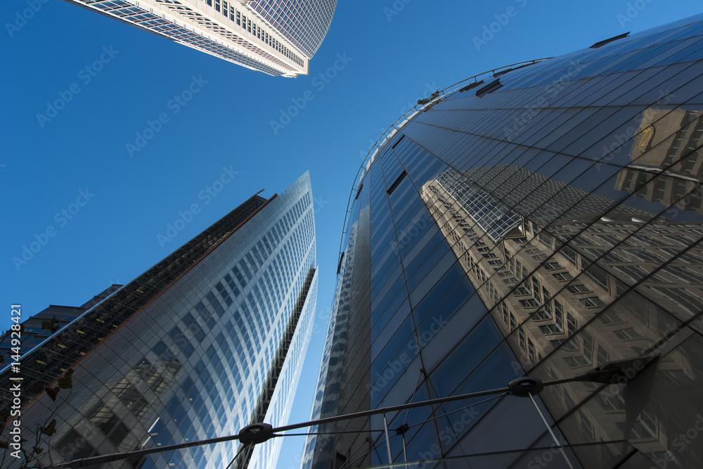 Reflections Corporate office buildings against blue sky in the city of ...