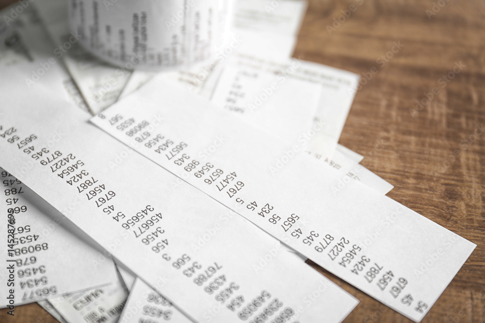Checks with numbers on wooden table, closeup. Tax concept Stock Photo ...