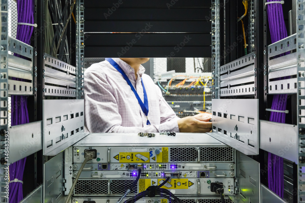 IT Engineer installs JBOD to rack in datacenter Stock Photo | Adobe Stock
