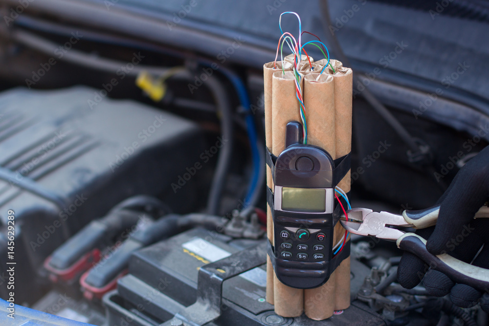 A bomb under the hood near the engine of the car. Explosive with a ...