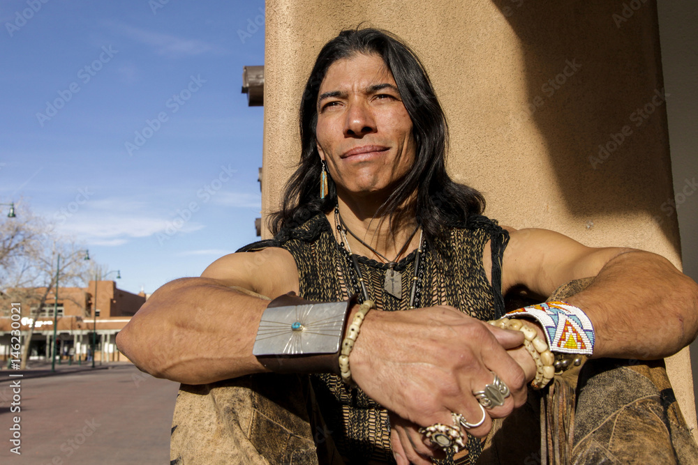 Native American man sitting against post Stock Photo | Adobe Stock