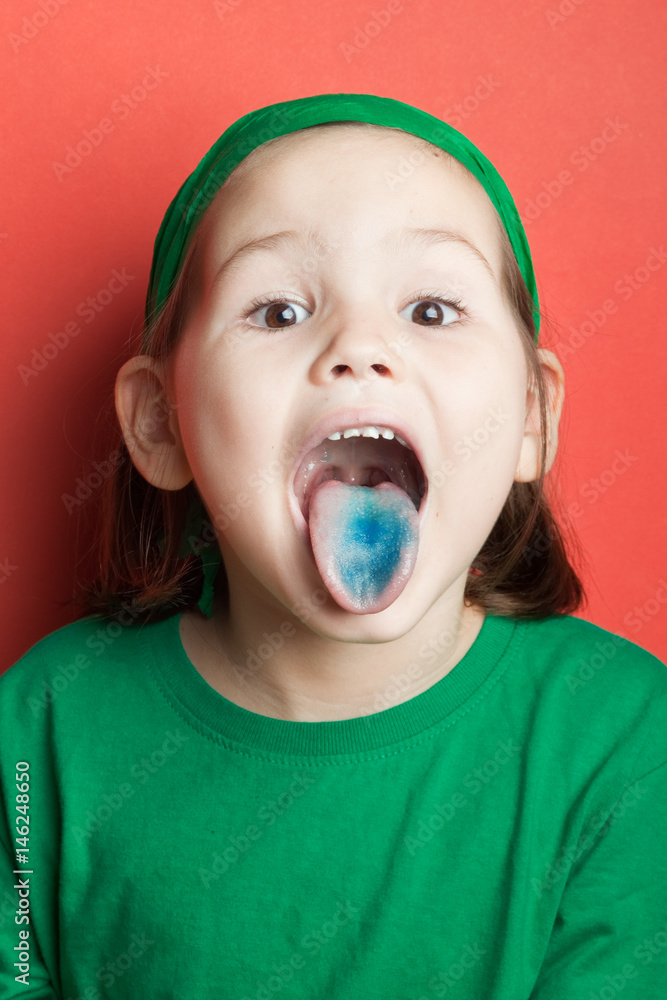 Little girl with blue tongue Stock Photo | Adobe Stock