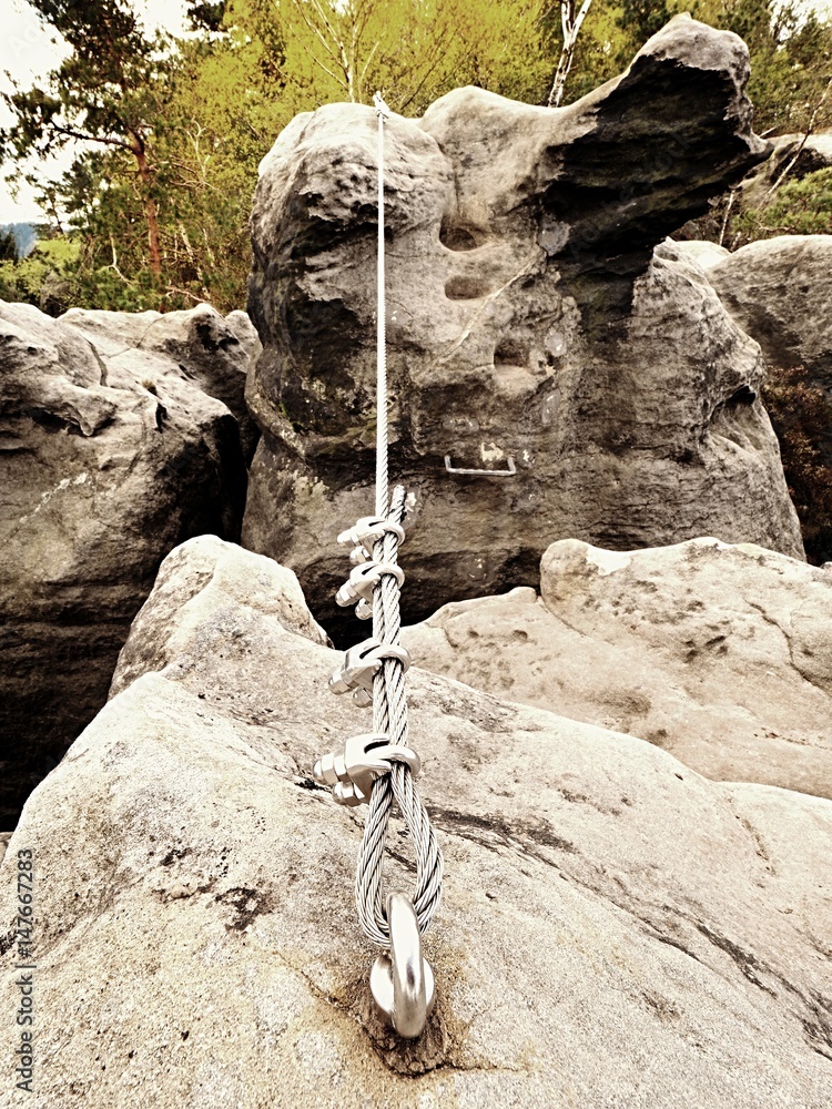 Iron twisted rope stretched between rocks in climbers patch via ferrata ...