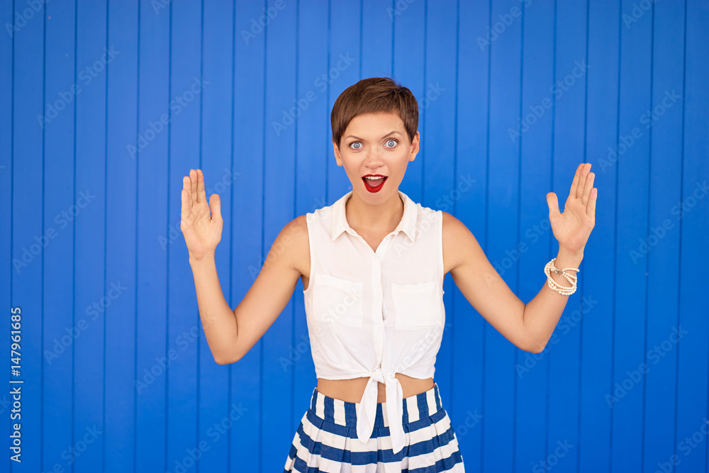It is so big. Colorful studio portrait of pretty young woman showing ...