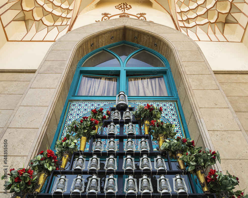 kerosene lamps and artificial flowers in front of a mosque, as a symbol ...