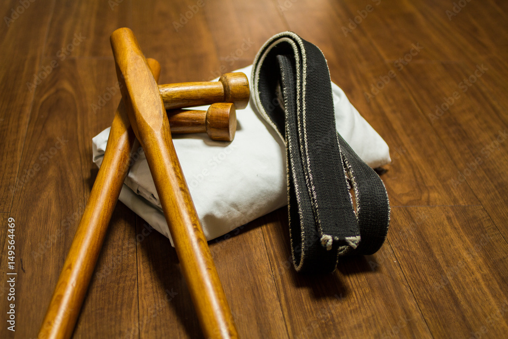 Tonfa ( traditional okinawan karate's weapon) , black belt and Gi ...