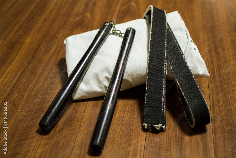 Nunchaku ( traditional okinawan karate's weapon) , black belt and Gi ...