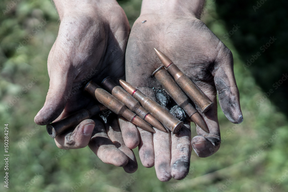Bullets from AK Kalashnikov AK 47 in the hands of a man. Concepts of ...