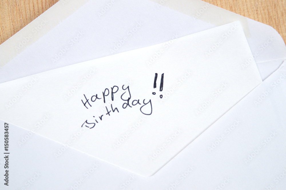 Happy Birthday, handwritten letter in white envelope, wooden background ...