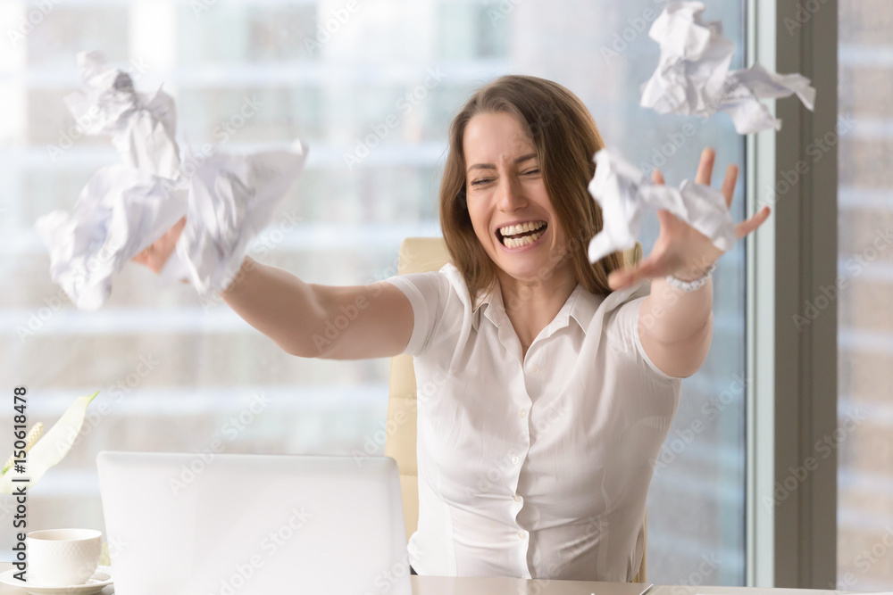 Furious businesswoman with wrathful face expression throwing crumbled ...