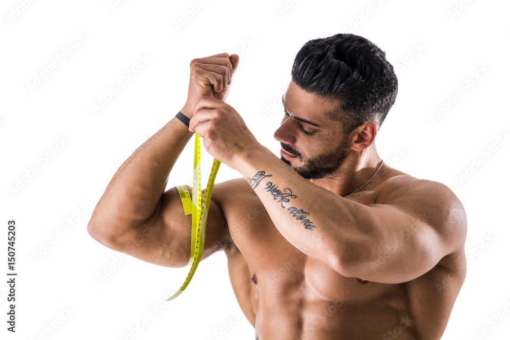 Muscular bodybuilder man measuring thigh with tape measure, close-up ...