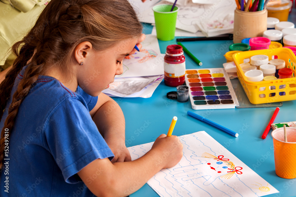 Small student girl close-up painting in art school class. Child drawing ...