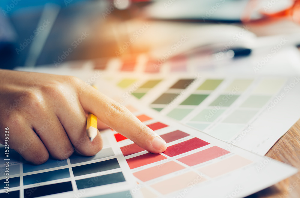 Graphic designer architects who work with laptops and color comparison ...