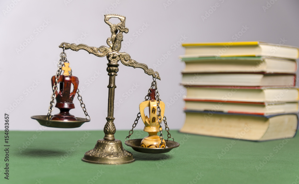 Scales of justice concept, chess kings on scales, white king outweighs ...