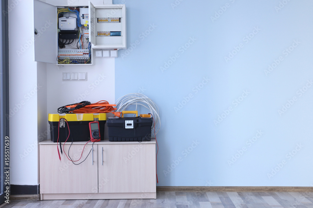 Distribution board with wires and tools on table in light room Stock ...