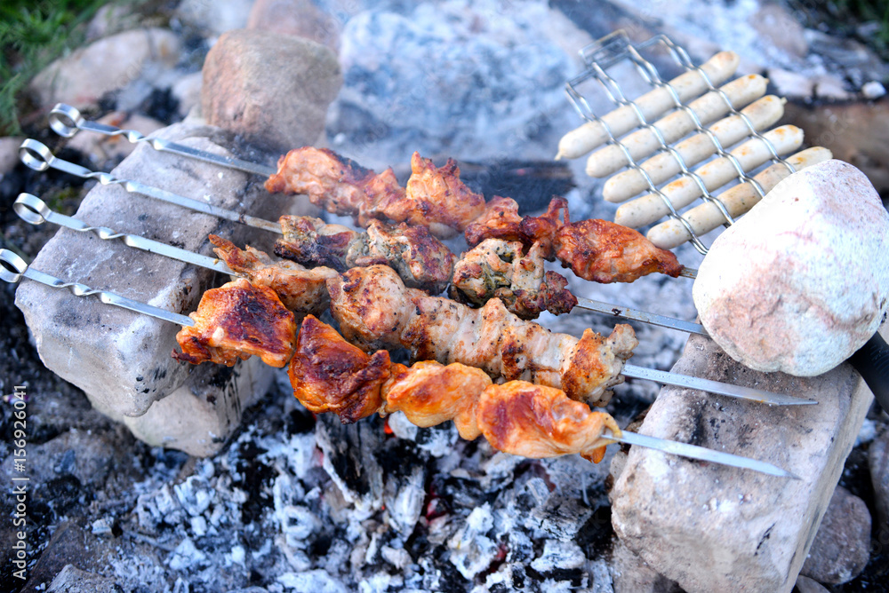 Grilling marinated shashlik on a grill. Shashlik is a form of Shish ...