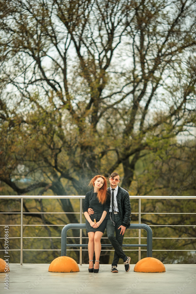 Couple in love. Modern haircuts. Handsome guy in headphones and pretty ...