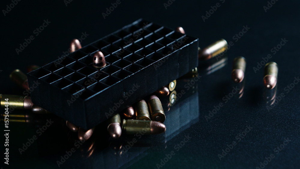 Bullets on the black mirror floor. Bullets are a projectile expelled ...