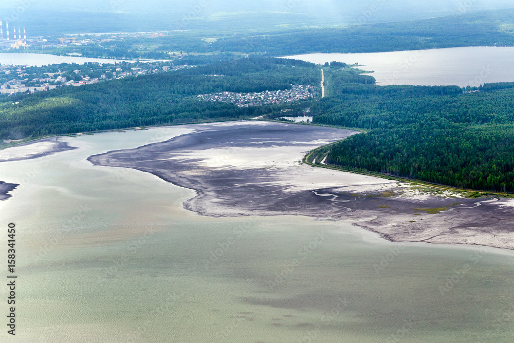 Sludge waste. Dirty blue and green water in reservoir. Environmental ...