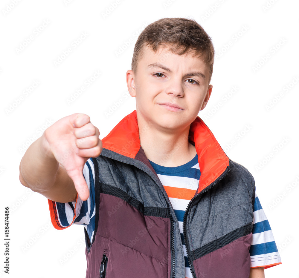Emotional portrait of unhappy teen boy giving thumbs down hand gesture ...