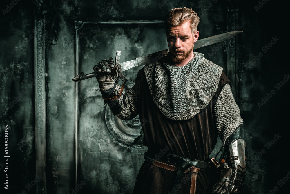 Medieval knight with sword and armour Stock Photo | Adobe Stock