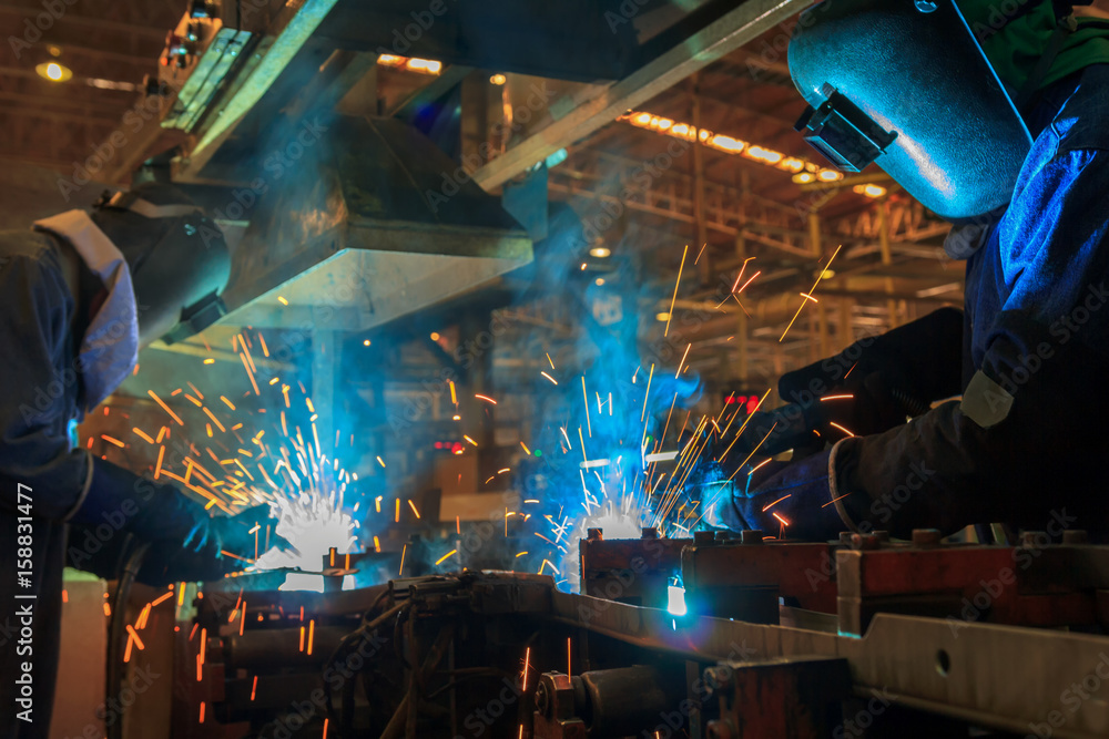 workers are welding assembly car parts in automotive industrial factory ...