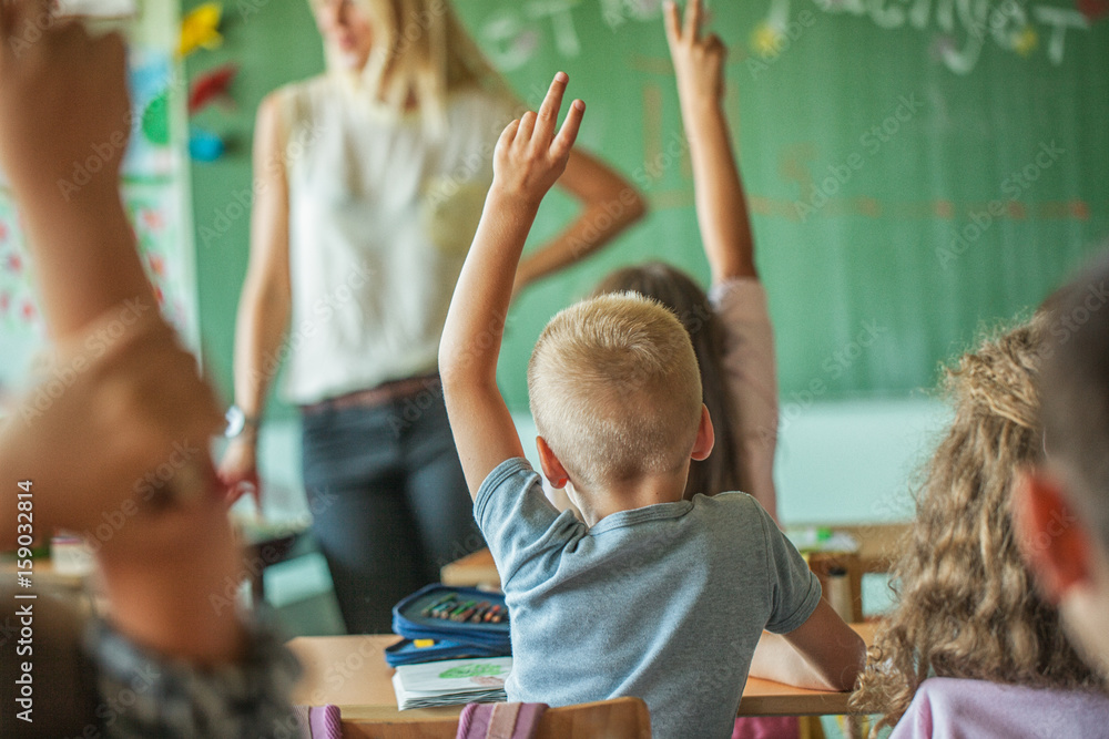 Students raising hands in the classroom Stock Photo | Adobe Stock