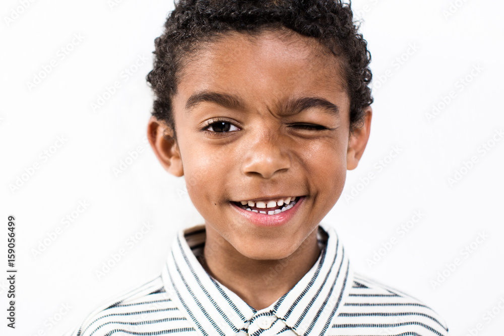 Little boy winking over white background Stock Photo | Adobe Stock