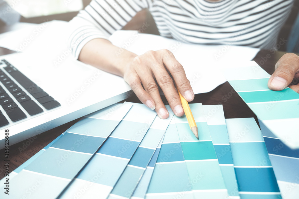 Graphic design and color swatches and pens on a desk. Architectural ...