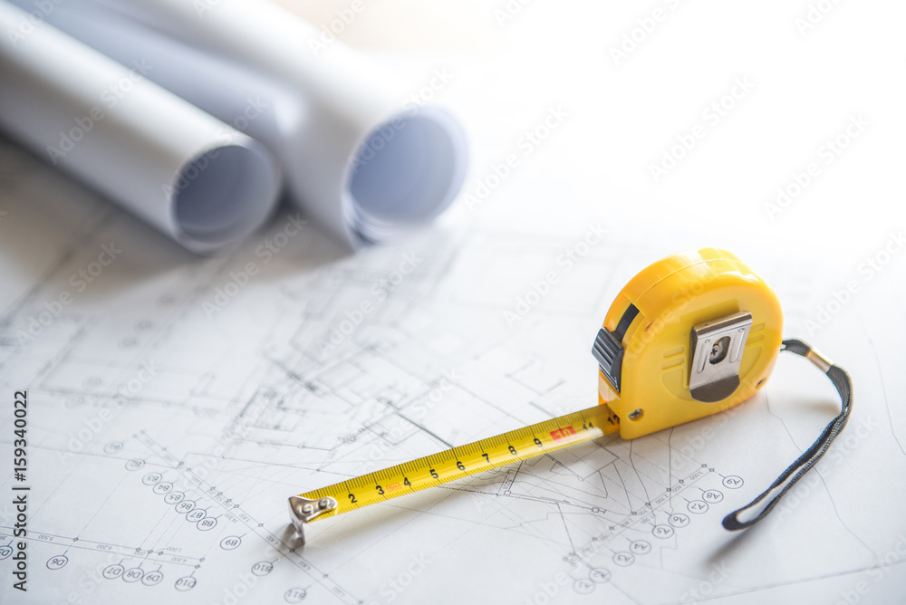 architectural drawing plan of house project, blueprint rolls and yellow ...